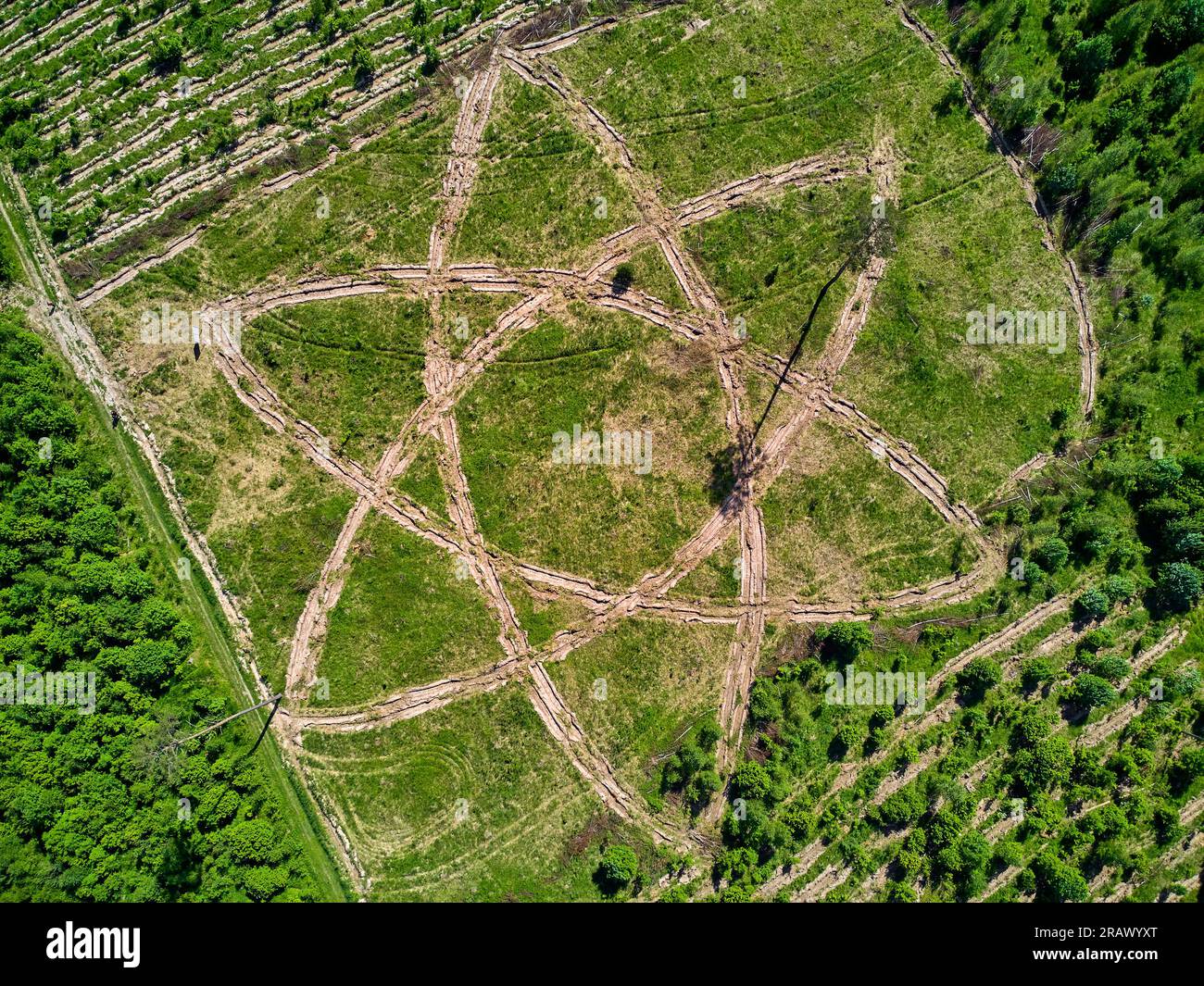 Geoglyph in the form of an atom symbol, an outline where trees are ...