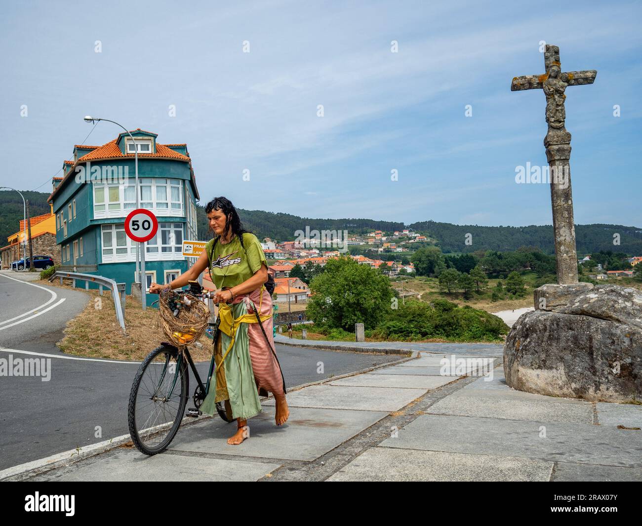 A woman with her bike is seen arriving in the city. The Camino de ...