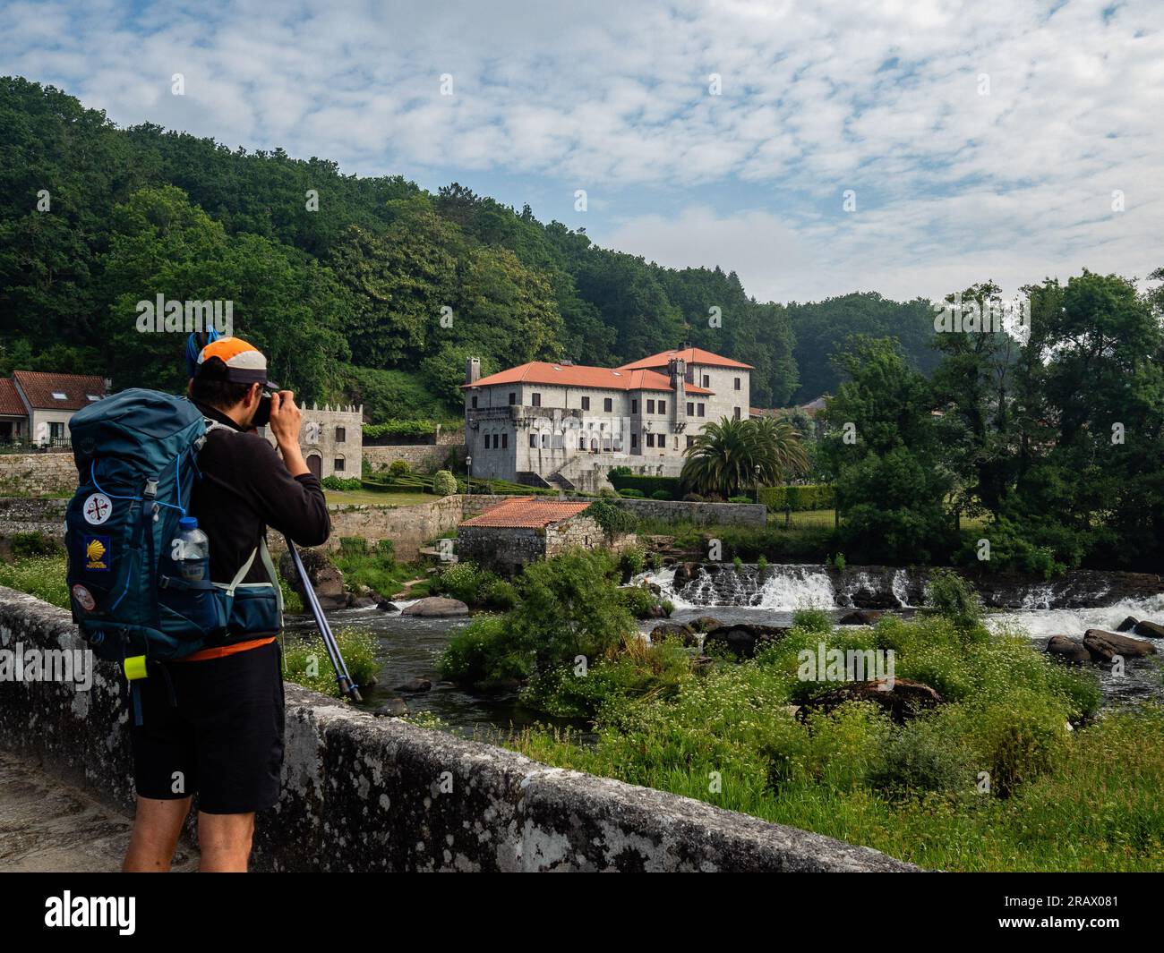 A pilgrim is seen taking a photo from a bridge of a beautiful parish ...