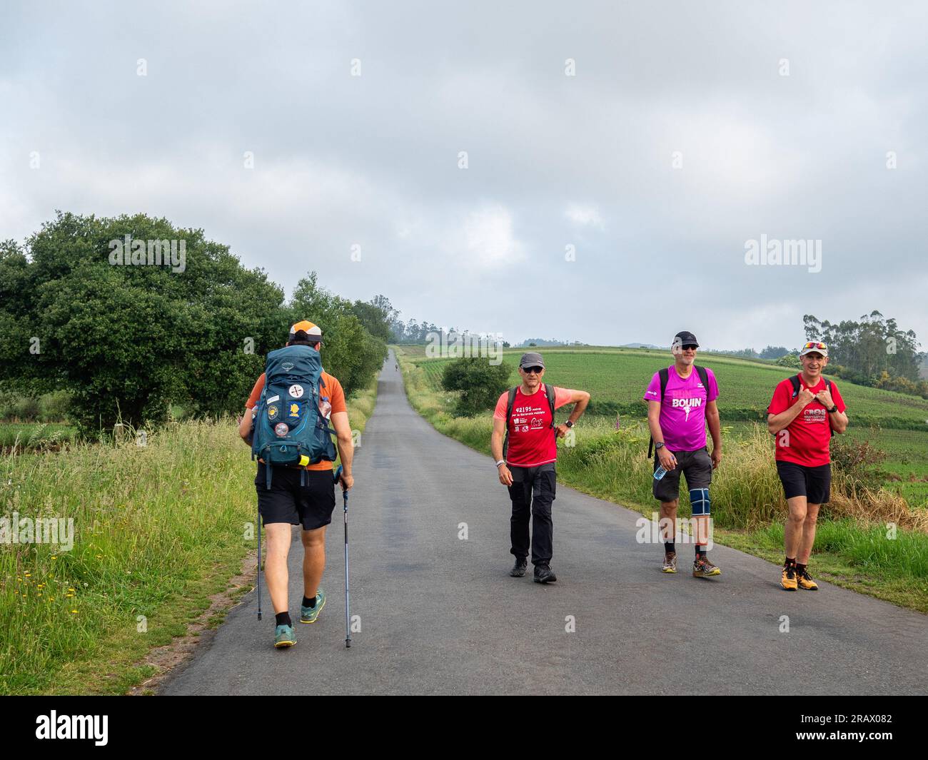 A pilgrim is seen passing by a group of pilgrims going in the other ...