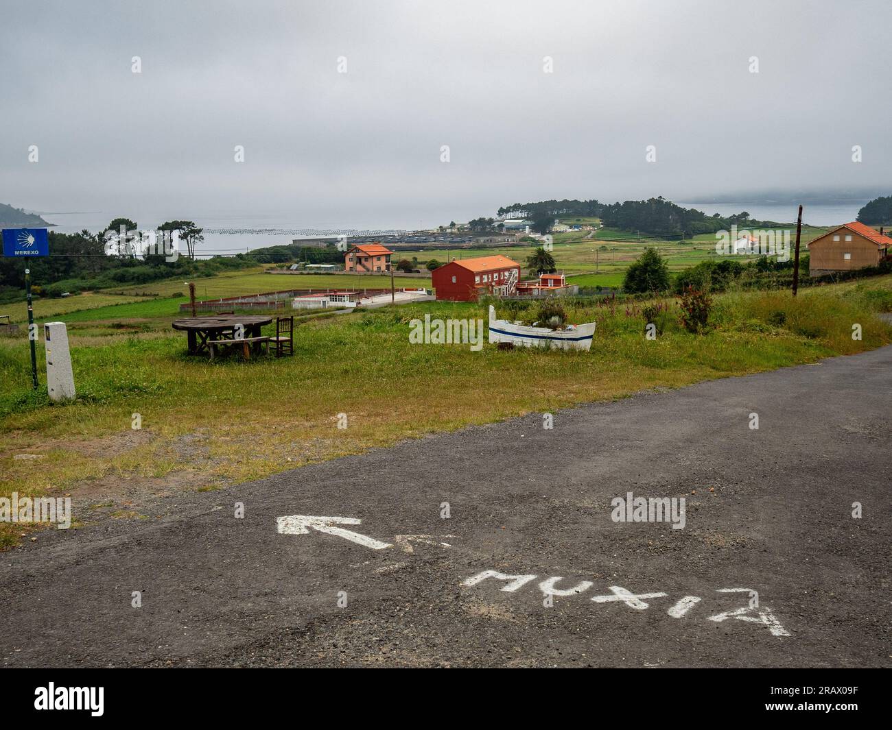 A view of a direction written on the ground pointing to the city. The ...