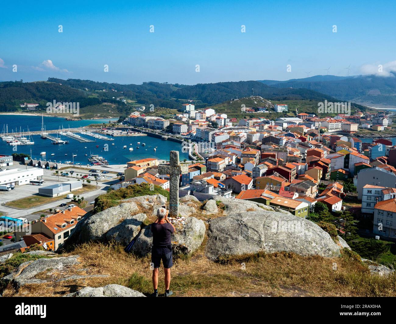 June 5, 2023, Muxia, Spain: A man is seen taking a photo of the city ...