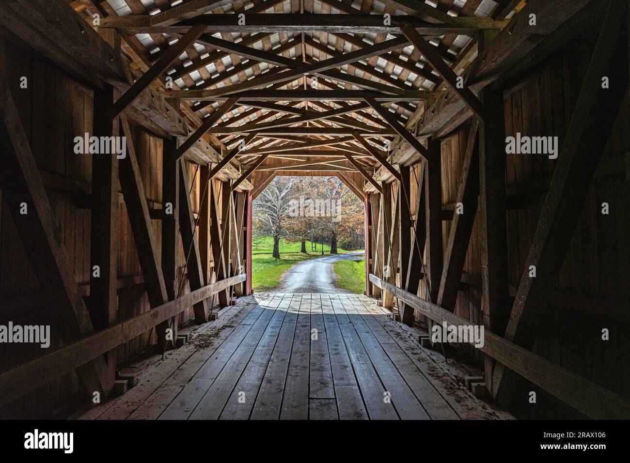 Looking through the interior of a historic wooden covered bridge to the ...