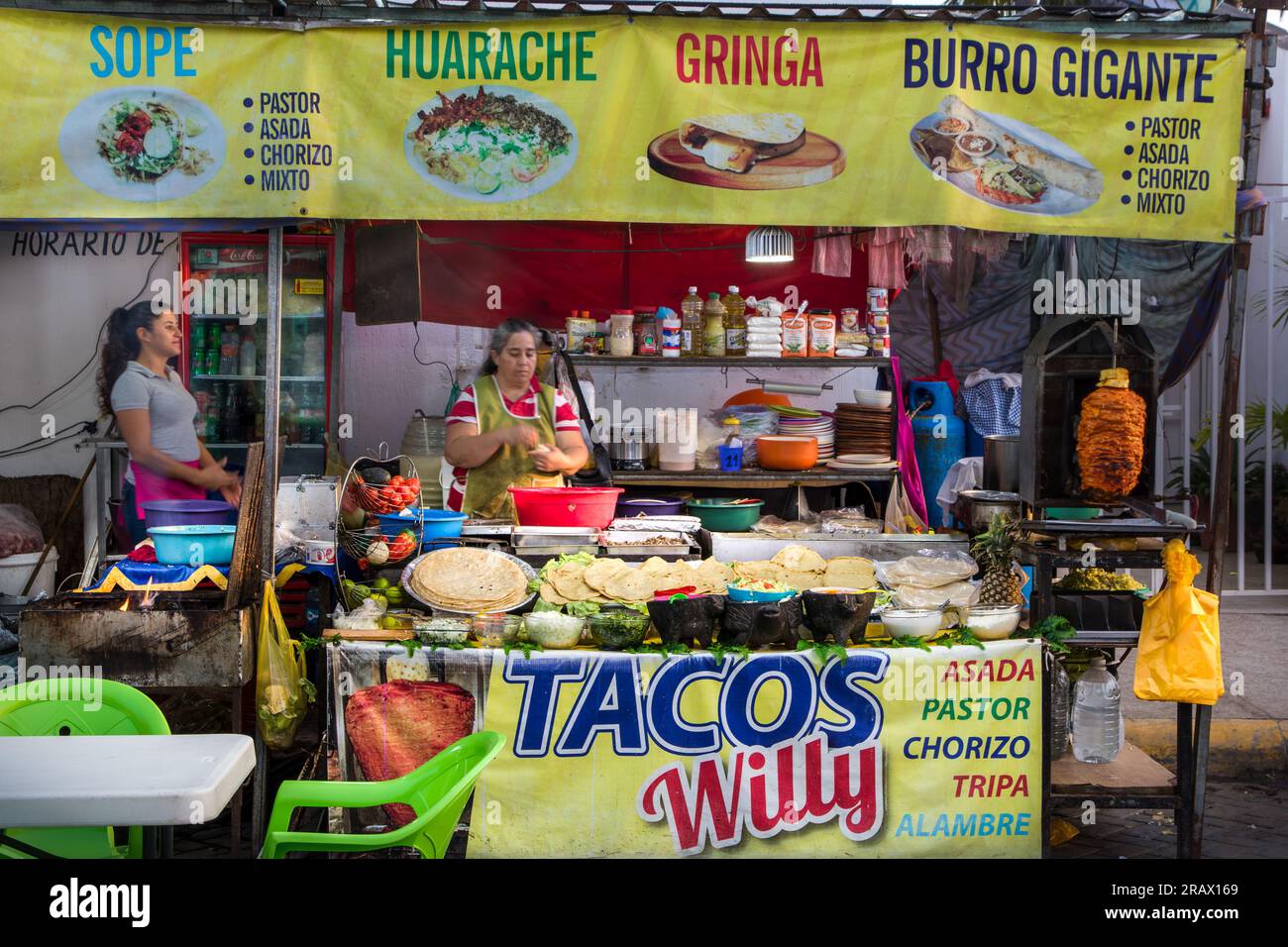 Women preparing food at an outdoor taco stand in Bucerias, Mexico Stock ...