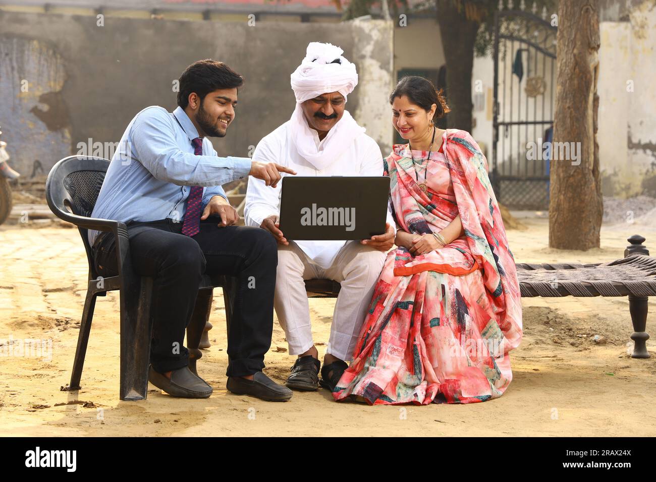 Happy rural Indian family in village Aspirational family sitting with a ...