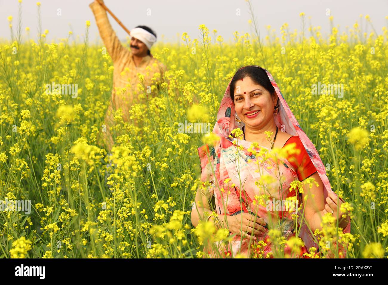 Happy rural Indian family standing in a mustard field. Happy to see the ...