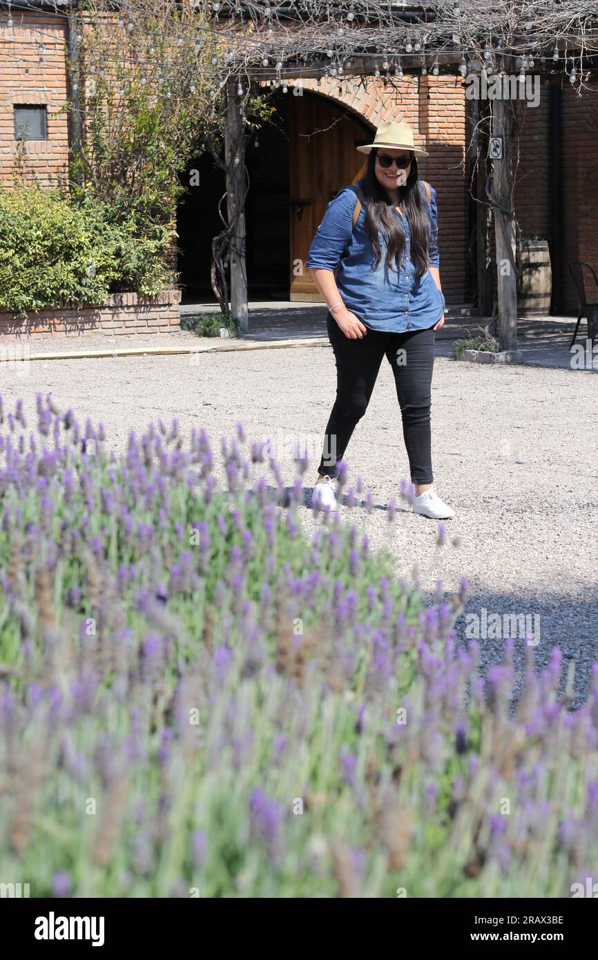 Latin adult woman walks relaxed and calm enjoys walk outdoors with ...