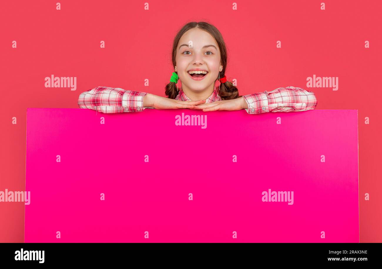 happy child with blank pink paper with copy space for advertisement ...