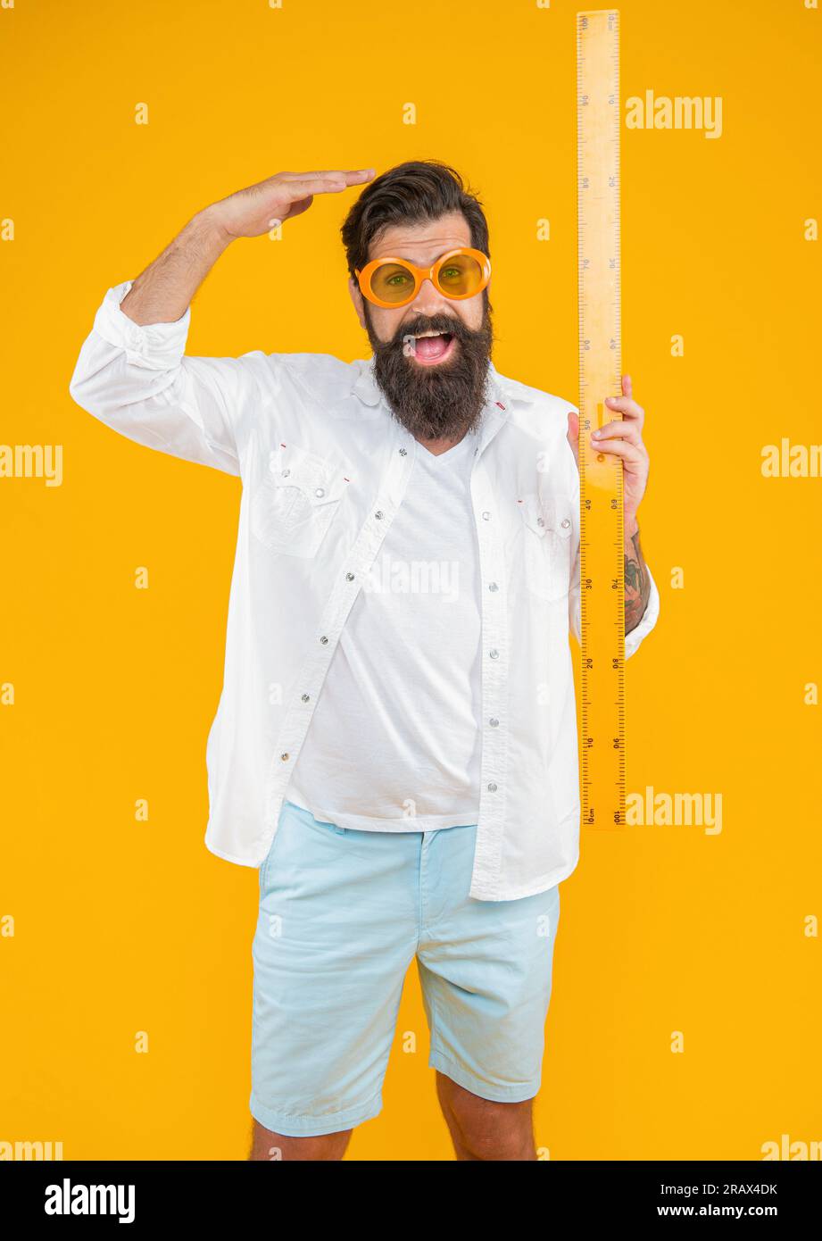 man hold measuring ruler shocked with height on background Stock Photo ...