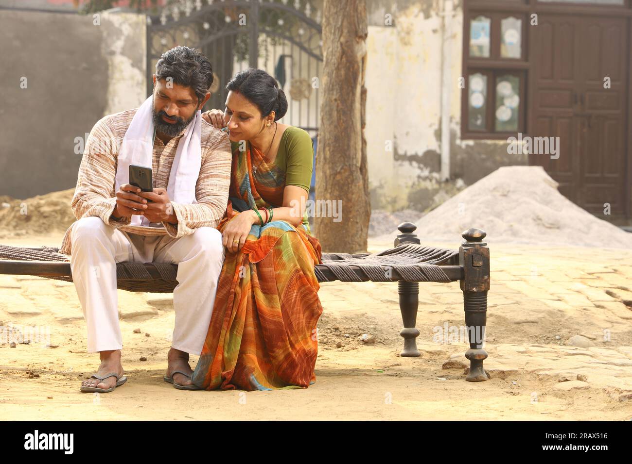 Happy Indian Rural family in village. couple sitting together outside ...