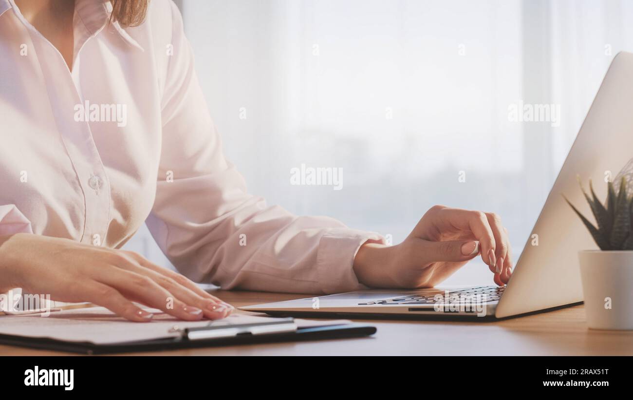 Secretary work office woman hands laptop checklist Stock Photo - Alamy