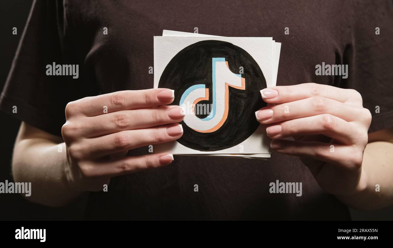 Tiktok logo social media application hands sign Stock Photo - Alamy