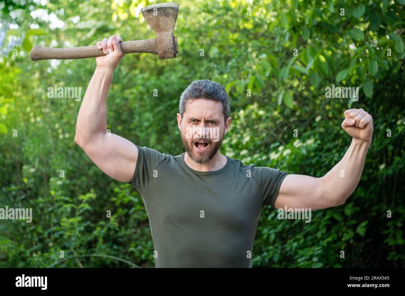 aggressive man hold axe outdoor. photo of aggressive man with axe ...
