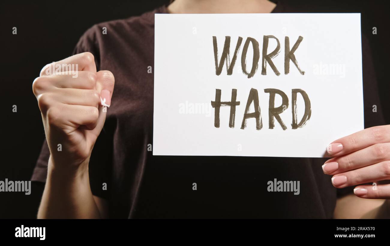 Work hard sign life challenge placard hand fist Stock Photo - Alamy