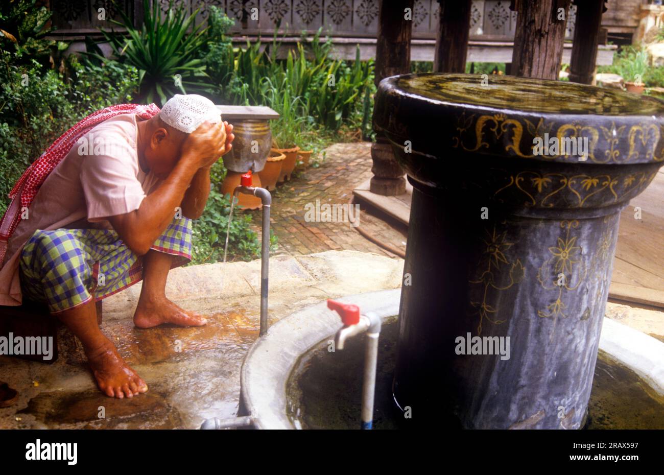 Imam of a mosque in south Thailand performs wudu before Friday prayers ...