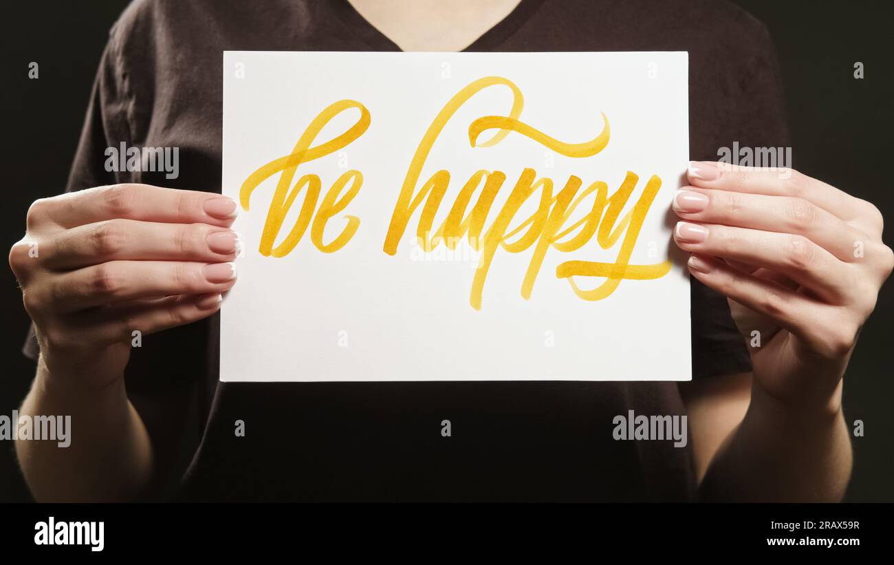 Be happy sign positive attitude support word hands Stock Photo - Alamy