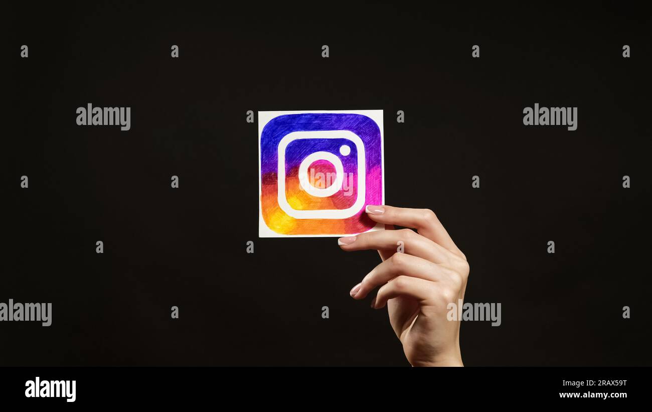 Instagram logo mobile hand dark hi-res stock photography and images - Alamy
