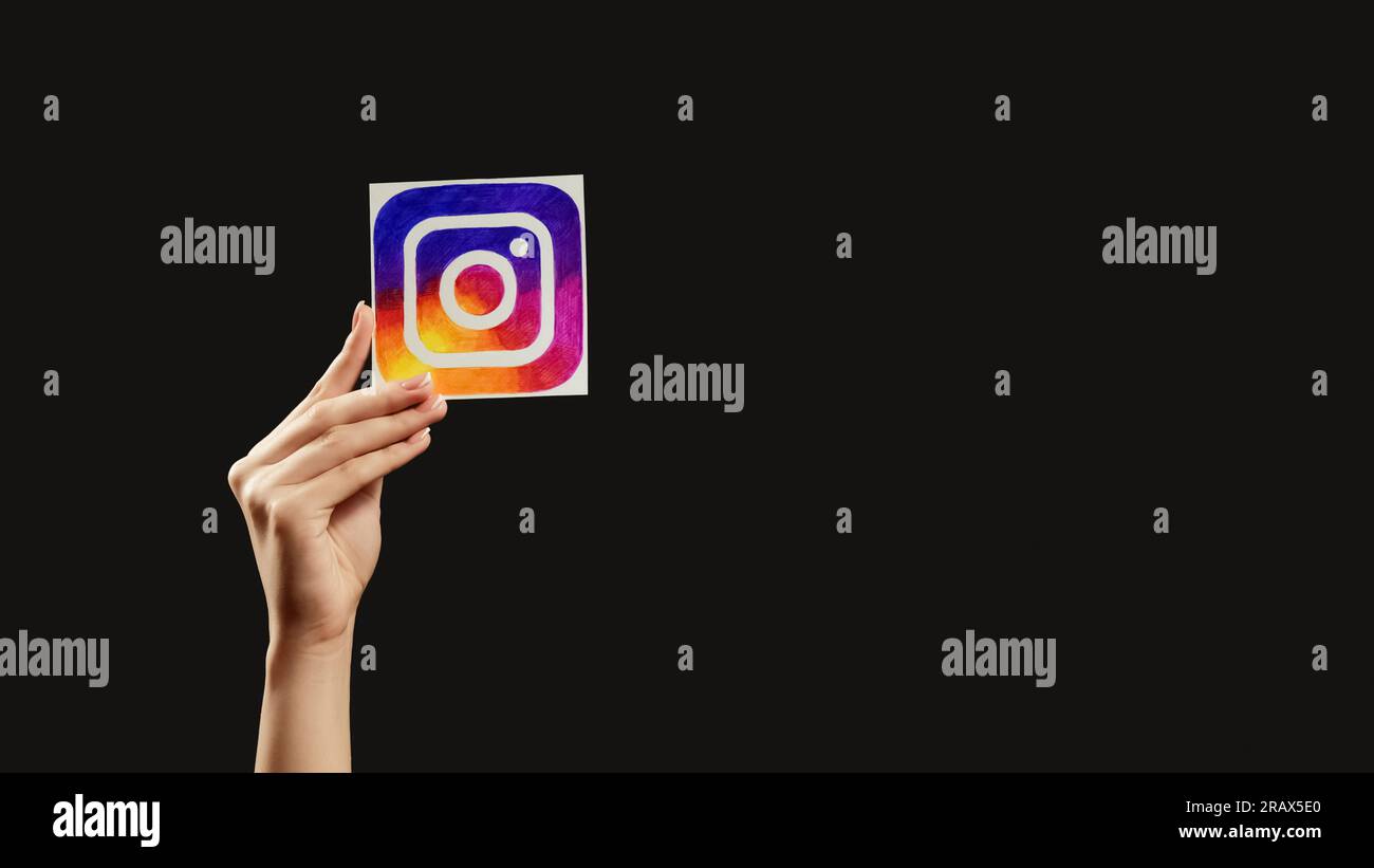 Instagram logo mobile hand dark hi-res stock photography and images - Alamy
