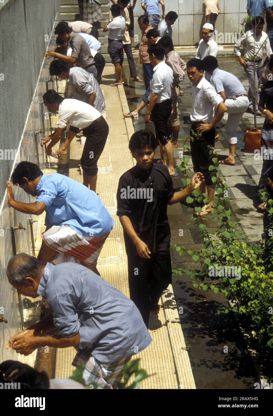 Muslims washing before offering prayers in a mosque in Selangor ...