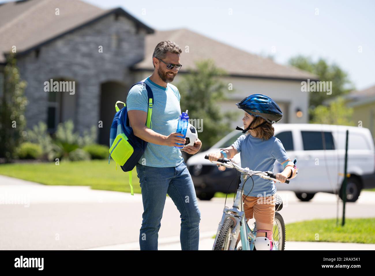 Father and son enjoying a ride together. Supportive father guiding son ...