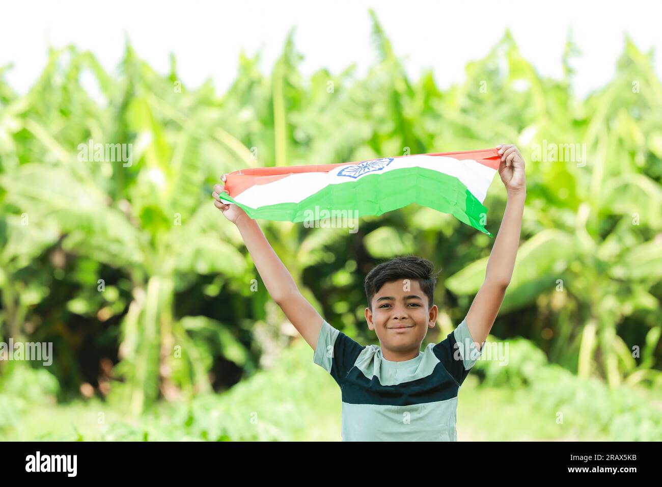 Indian boy holding national flag in farm, happy boy, national flag ...
