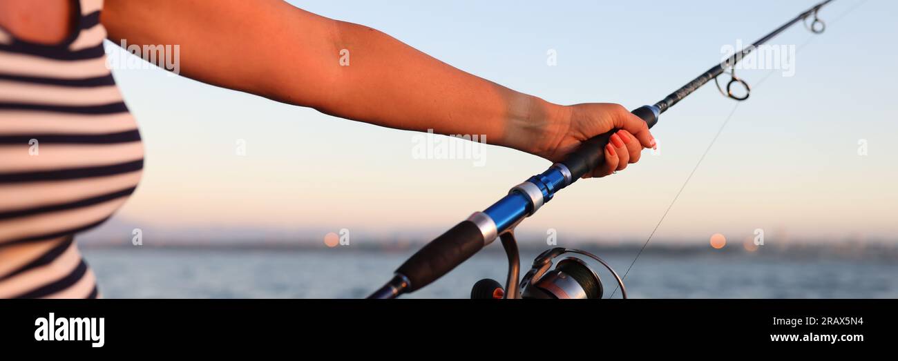 Female holding fish rod hi-res stock photography and images - Alamy
