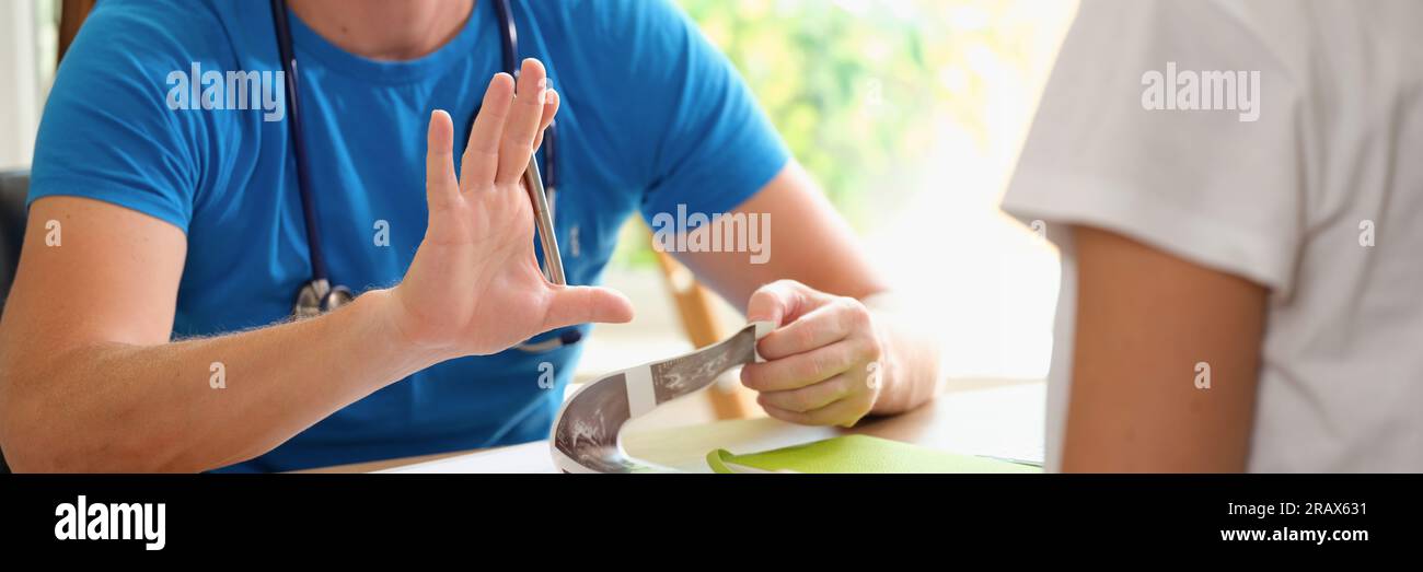 Male practitioner looking at description of ultrasound shots of calming ...