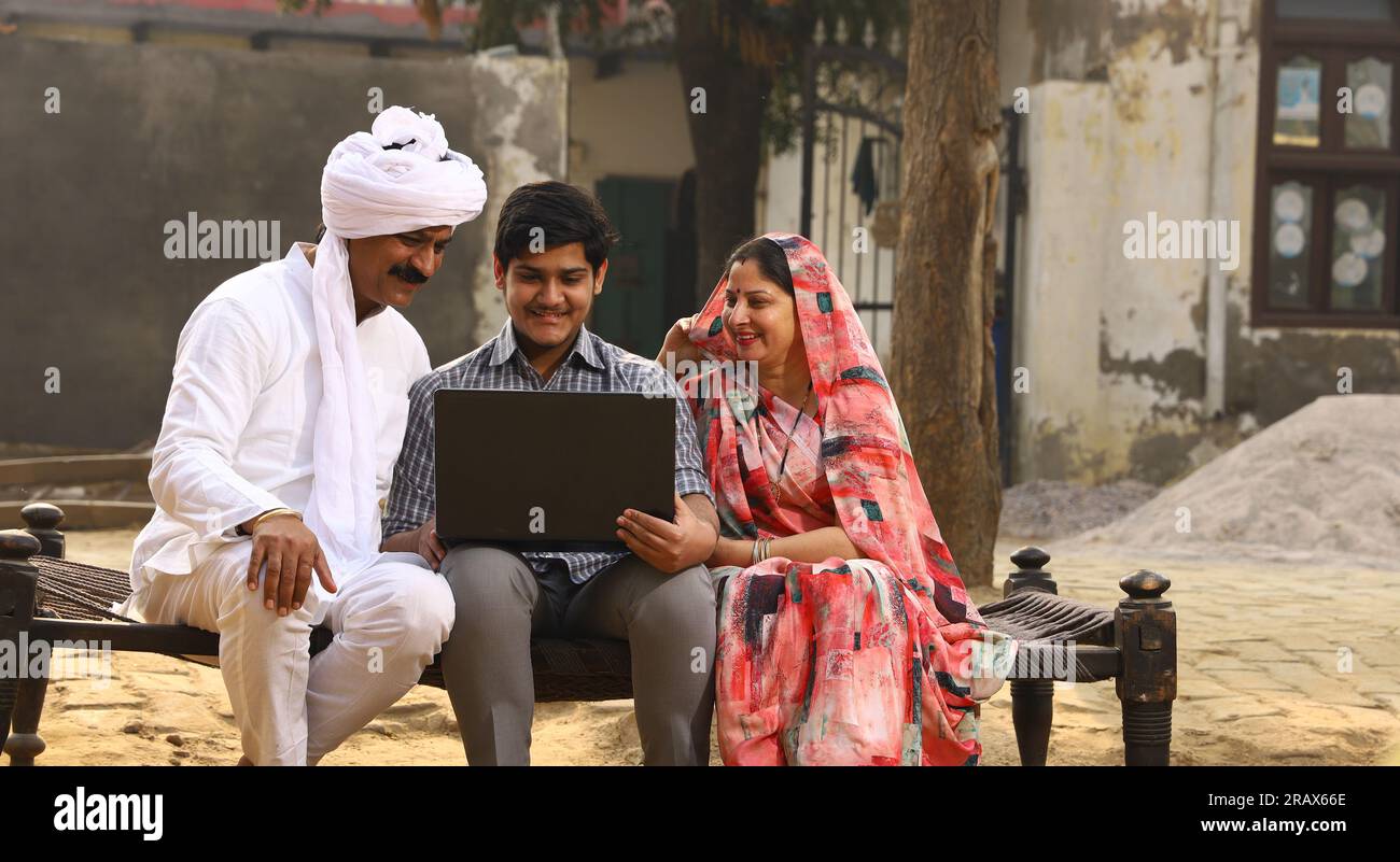 Happy rural Indian family in village Aspirational family sitting with a ...