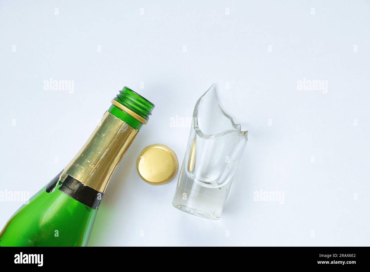 broken glass and empty bottle of alcoholic drink on white background ...