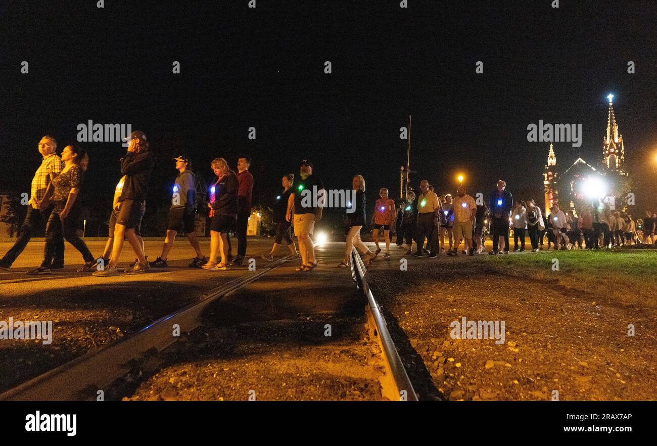 Lac Megantic, Canada. 06th July, 2023. People cross the train tracks as they take part in a ...