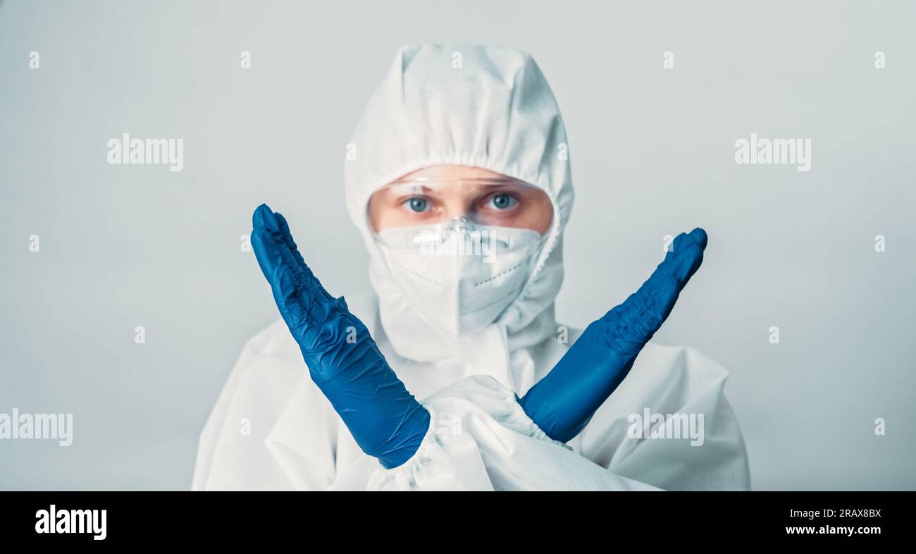 Medical worker woman doctor danger hands sign Stock Photo - Alamy