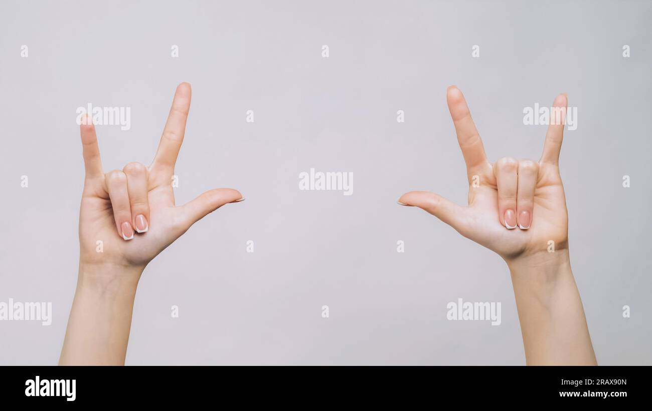 Rock sign punk gesture woman fingers showing horns Stock Photo - Alamy