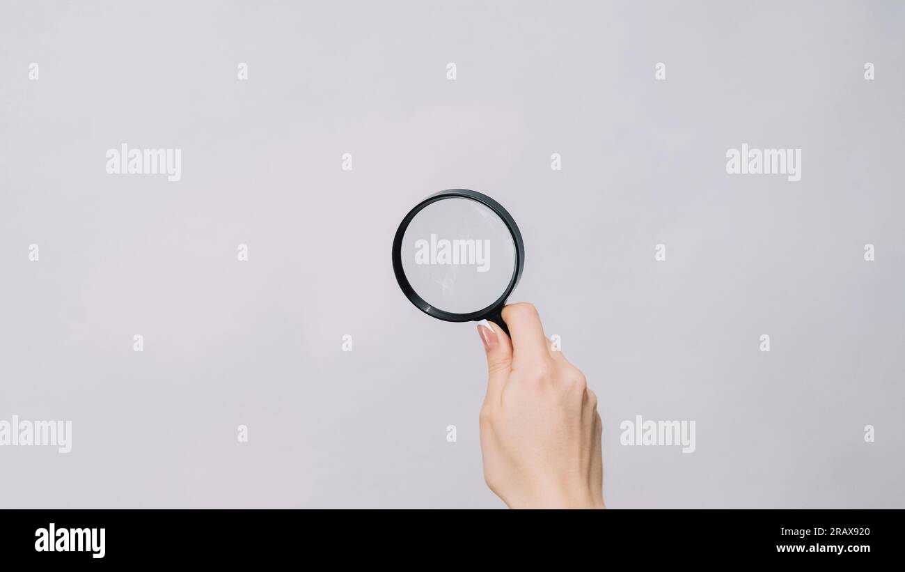 Zooming glass exploring lens woman hand studying Stock Photo - Alamy