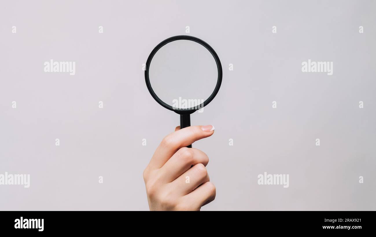 Magnifying loupe searching lens woman hand zooming Stock Photo - Alamy