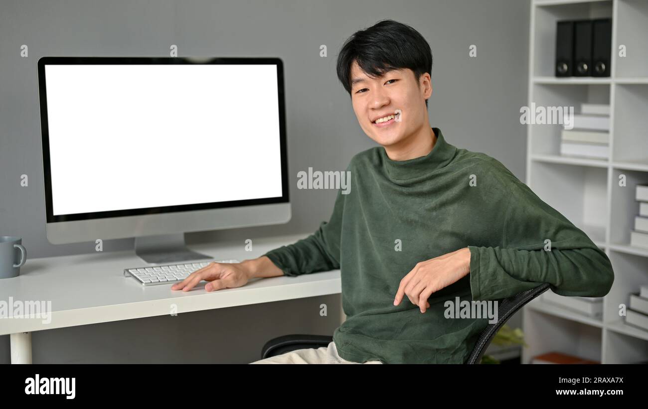 A portrait of a smart and handsome young Asian man in a casual clothes ...