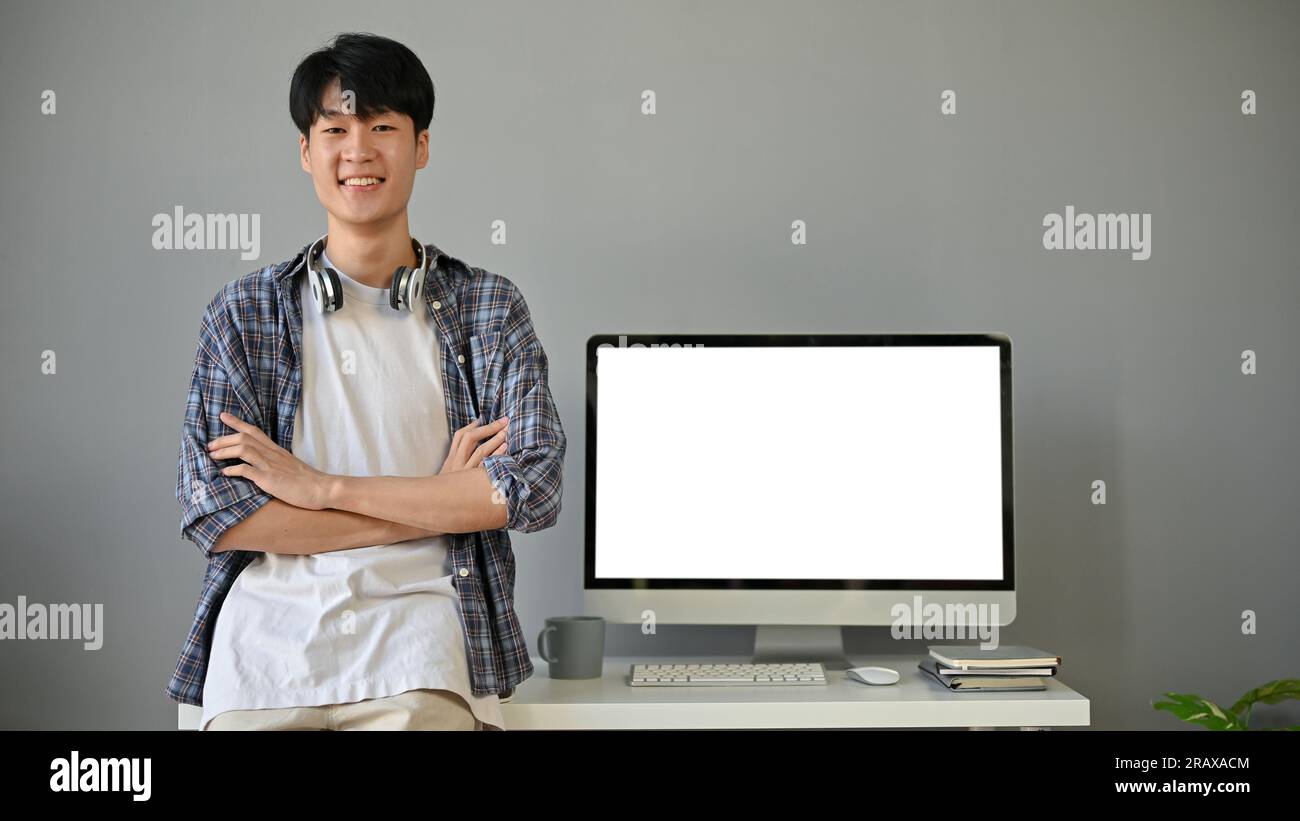 A smart and handsome young Asian male programmer in a casual clothes ...