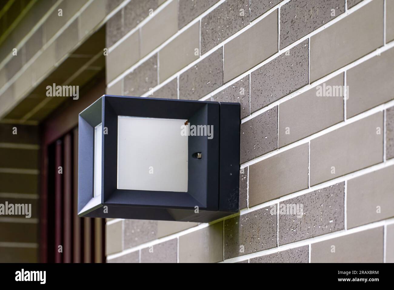 Closeup of a boxy modern style wall light Stock Photo - Alamy