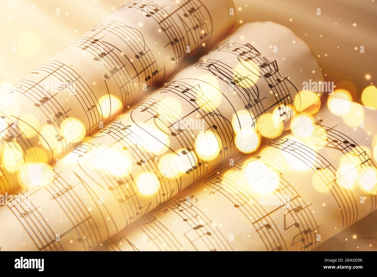 Rolled sheets with music notes on gold background, bokeh effect Stock ...