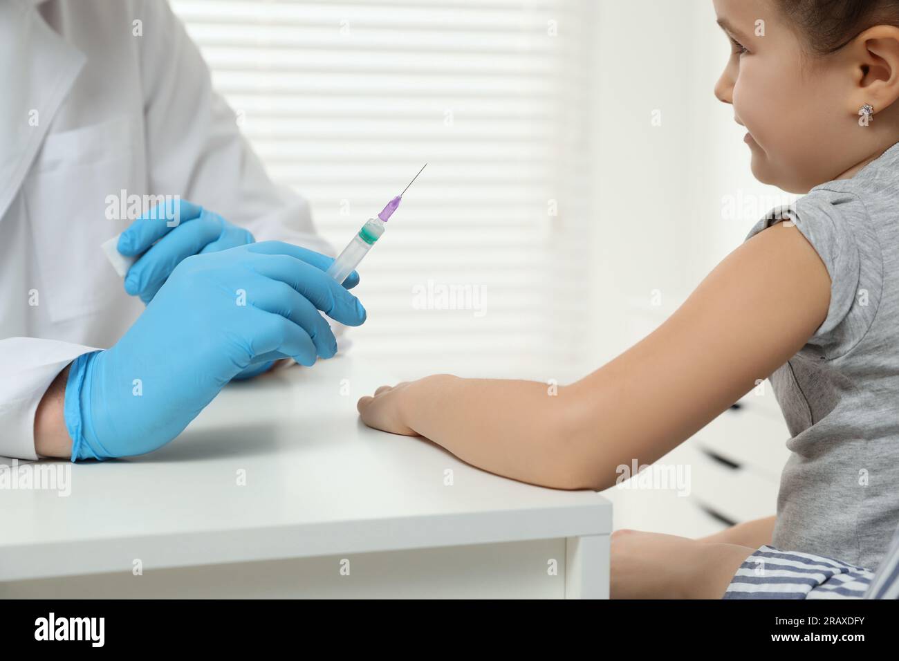 Children's hepatitis vaccination. Doctor giving injection to little ...