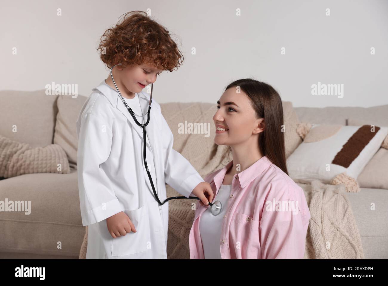 Little boy playing doctor with his mother at home Stock Photo - Alamy