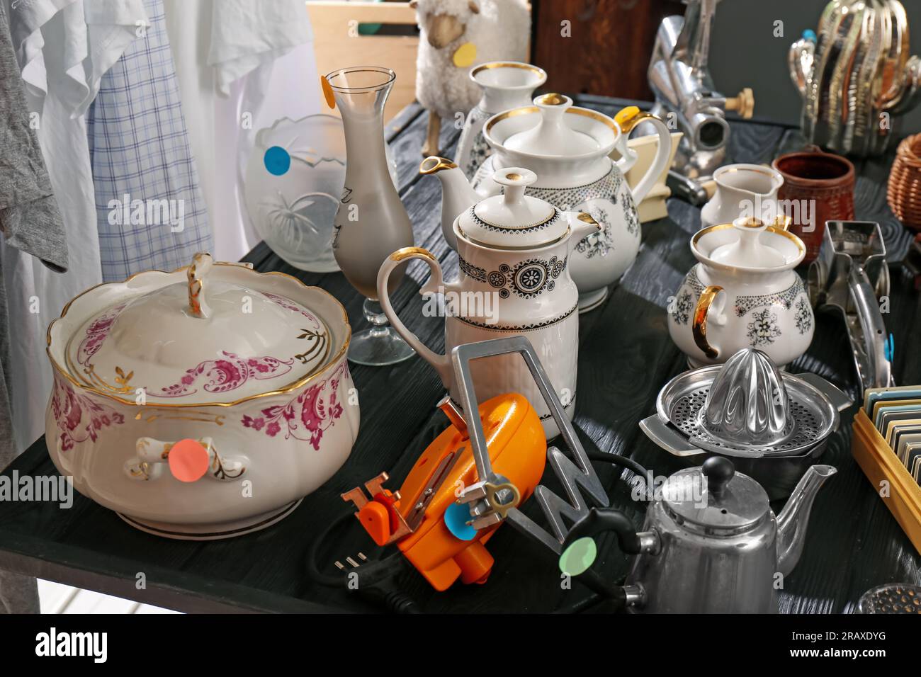 Many different stuff on black wooden table. Garage sale Stock Photo - Alamy