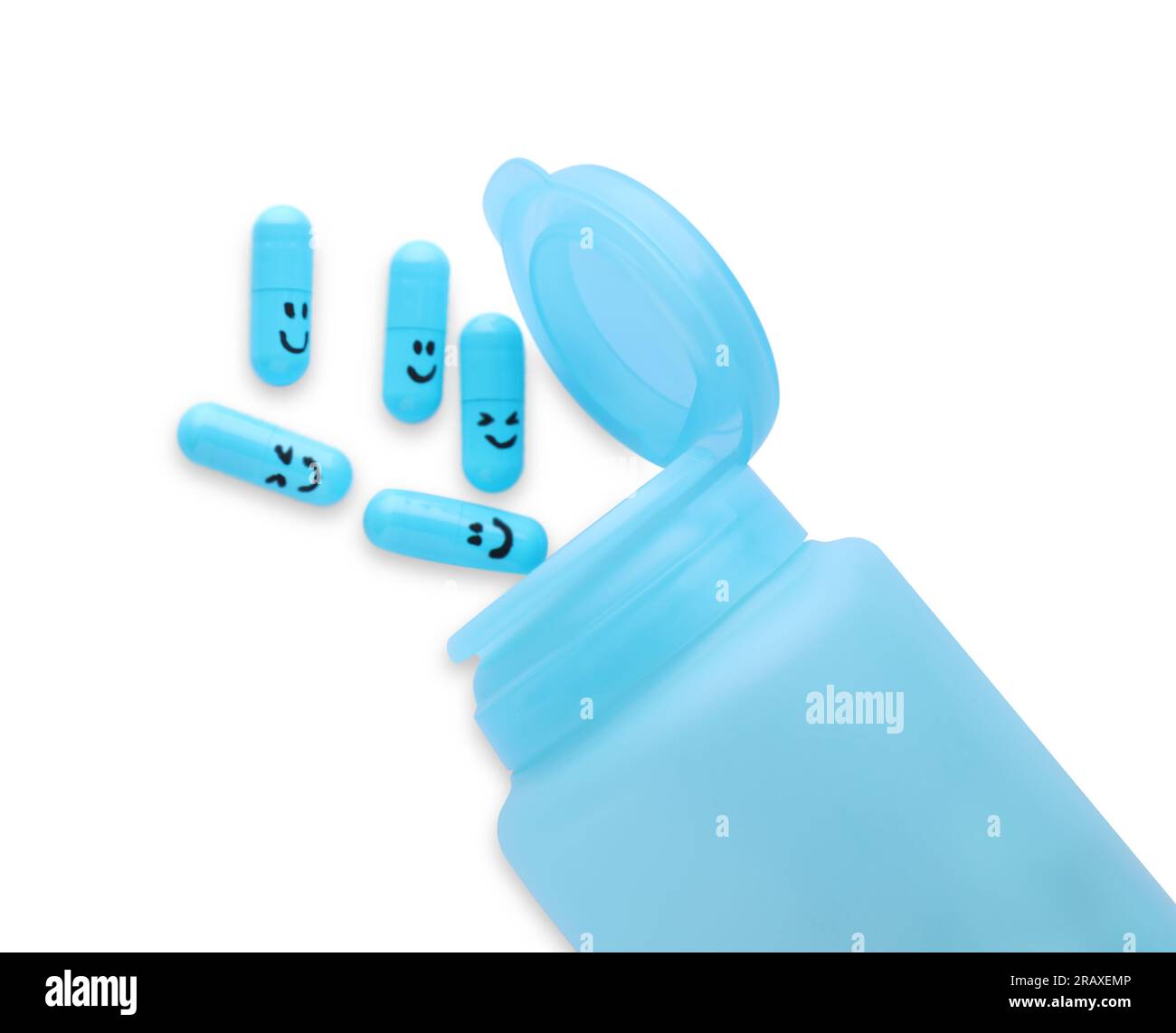 Bottle and antidepressant pills with funny faces on white background ...