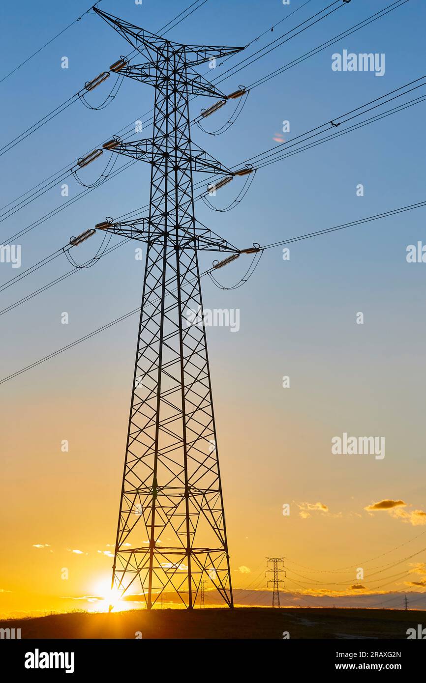 Power lines at sunset. Energy industry. Electricity transmission ...