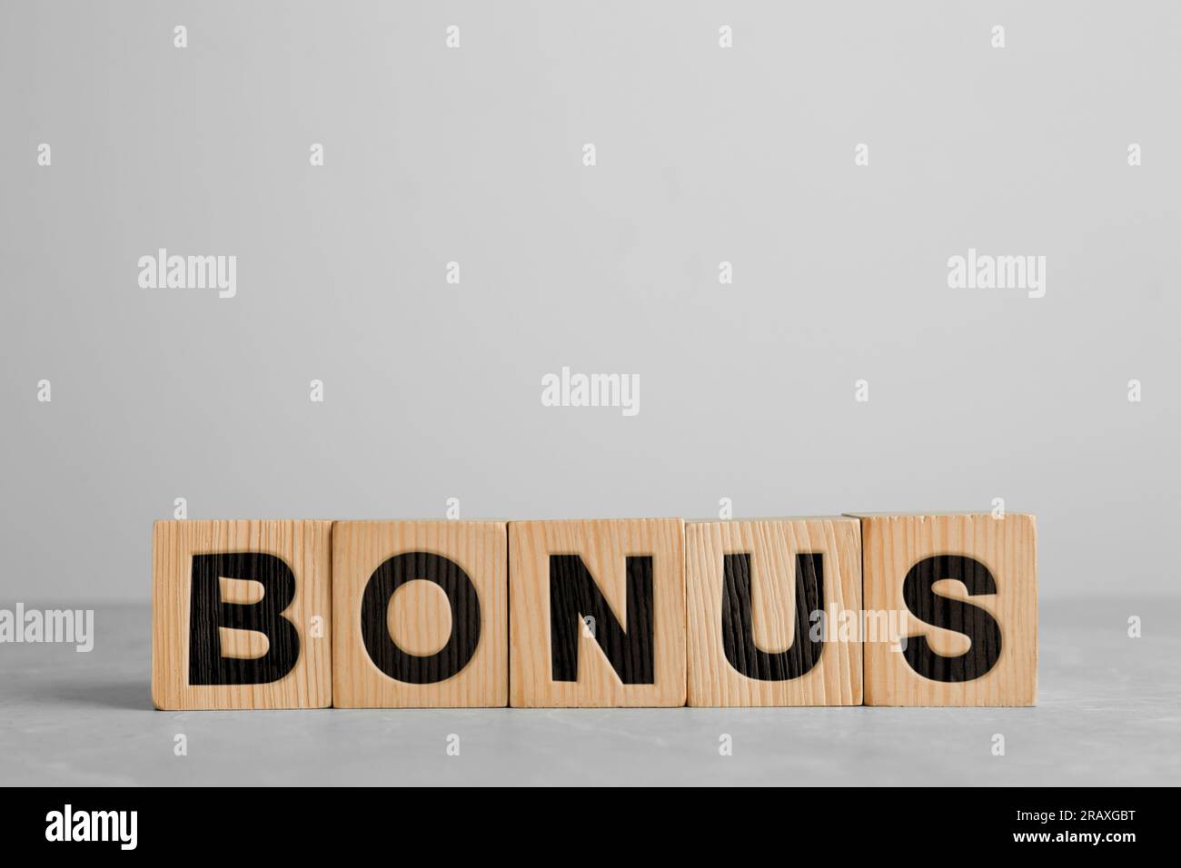 Word Bonus made of wooden cubes with letters on white background Stock ...