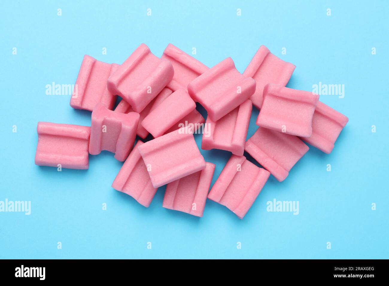 Tasty pink chewing gums on light blue background, flat lay Stock Photo ...