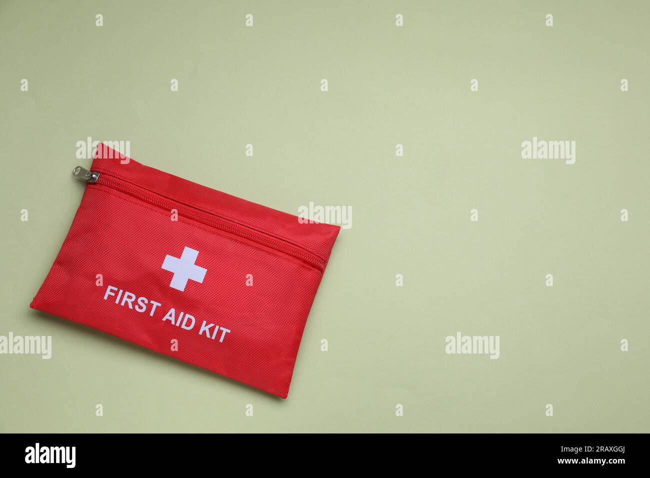 First aid kit on light green background, top view. Space for text Stock ...
