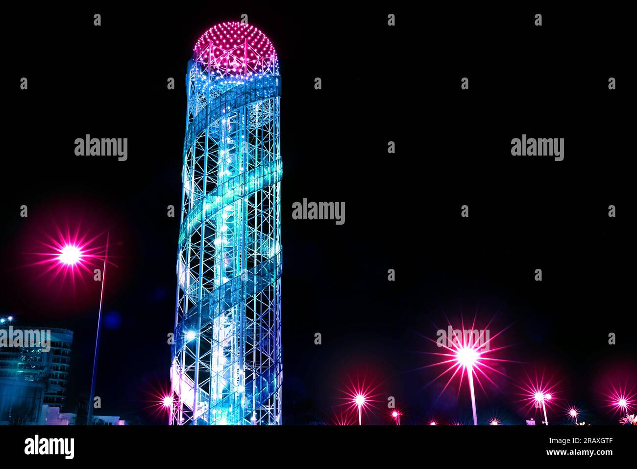 Tower illuminated by beautiful neon lights at night. Modern metropolis ...