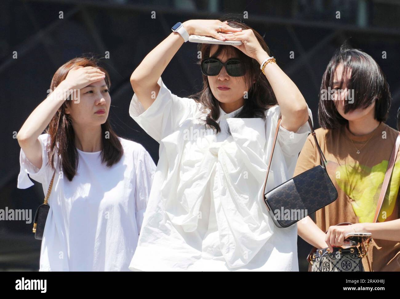 People walk in record-breaking heat wave in Beijing, China on July 6 ...
