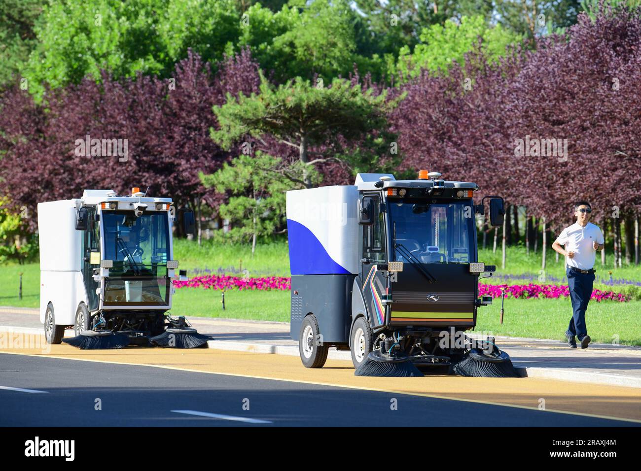 ORDOS, CHINA - JULY 6, 2023 - Two self-driving sweepers work on a ...