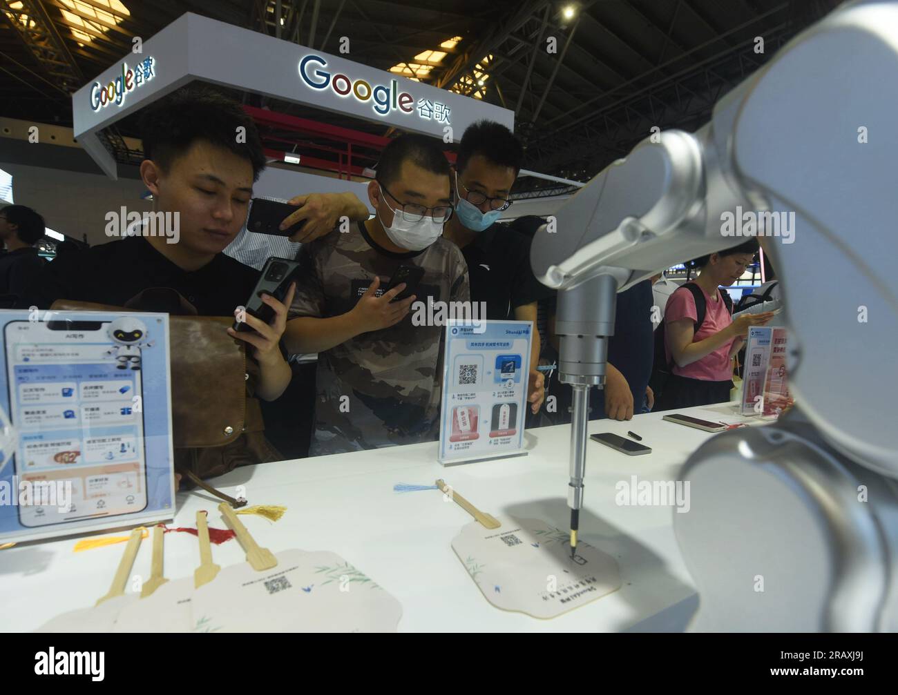 SHANGHAI, CHINA - JULY 6, 2023 - Visitors watch a robot write Chinese calligraphy at the 2023 ...